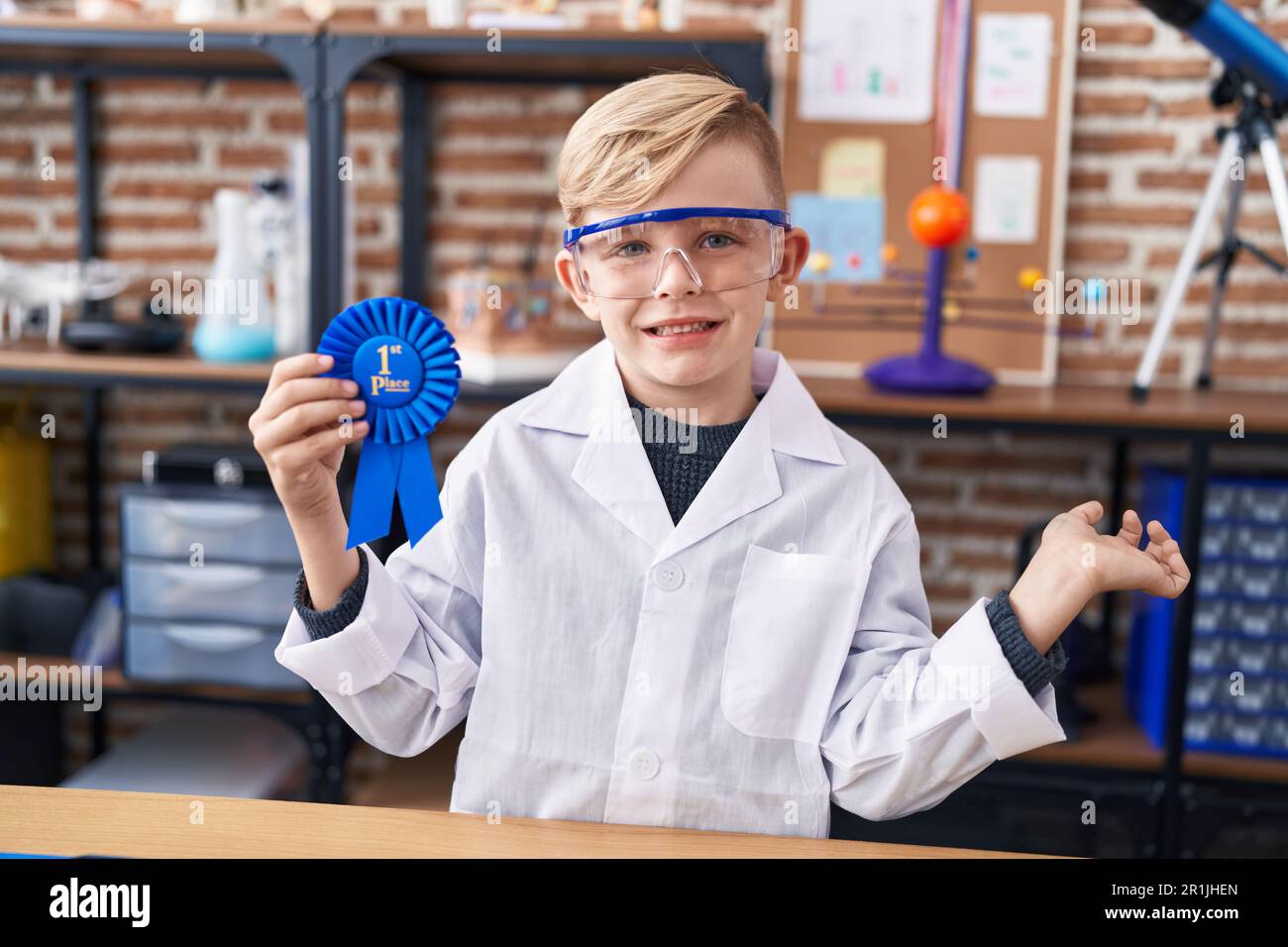 Little caucasian boy at school scientist laboratory winning first prize ...