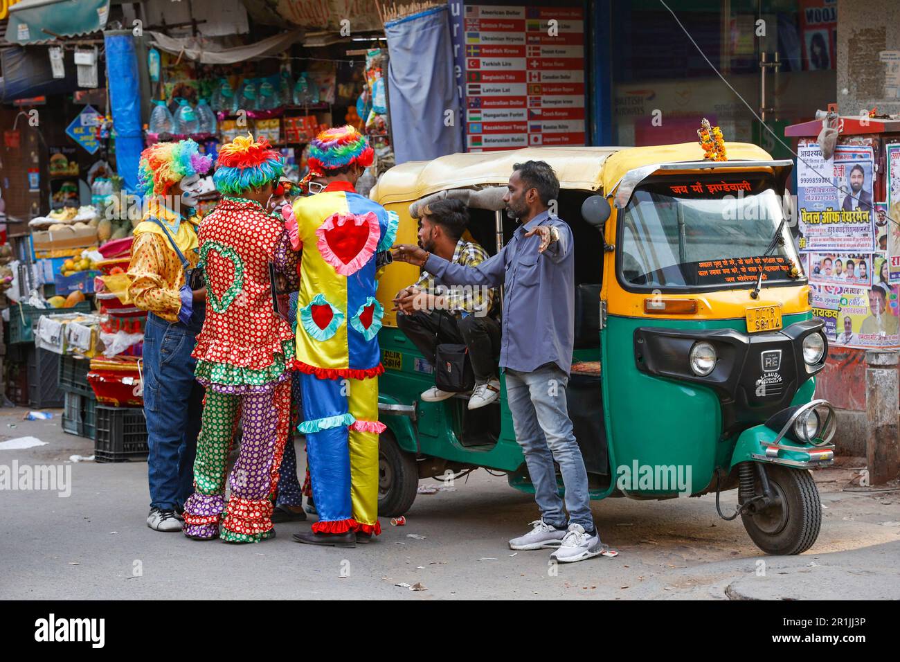 3 men dressded in colourful clown costume in Paharganj, Delhi, India ...