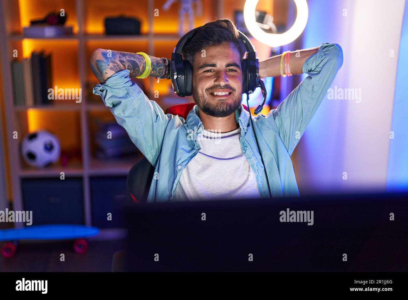Young hispanic man streamer smiling confident relaxed with hands on ...