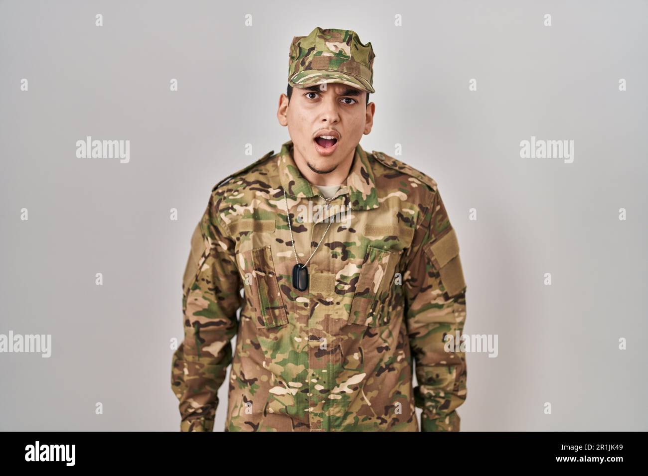 Young arab man wearing camouflage army uniform angry and mad screaming ...