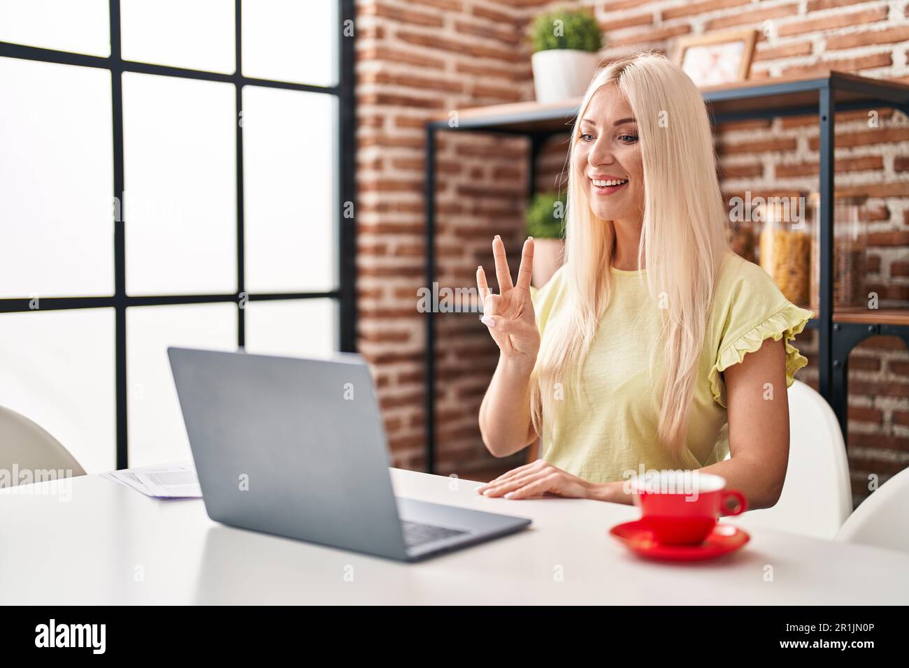 Young blonde woman having video call using deaf language at home Stock ...