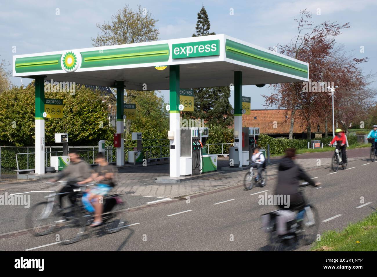 Empty BP gas station along a road with blurred cyclist in the Dutch ...