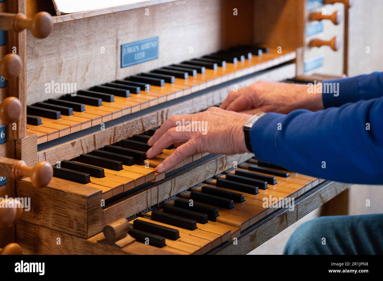 Hands of an organist playing a church organ in the 'Hobbe van Baerdt ...