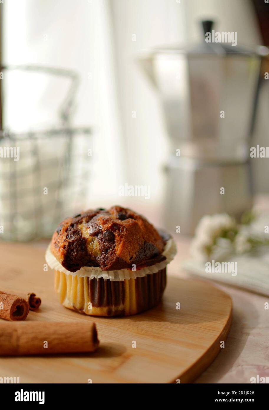 Vanilla-chocolate cake in a corrugated mold. There are cinnamon sticks ...