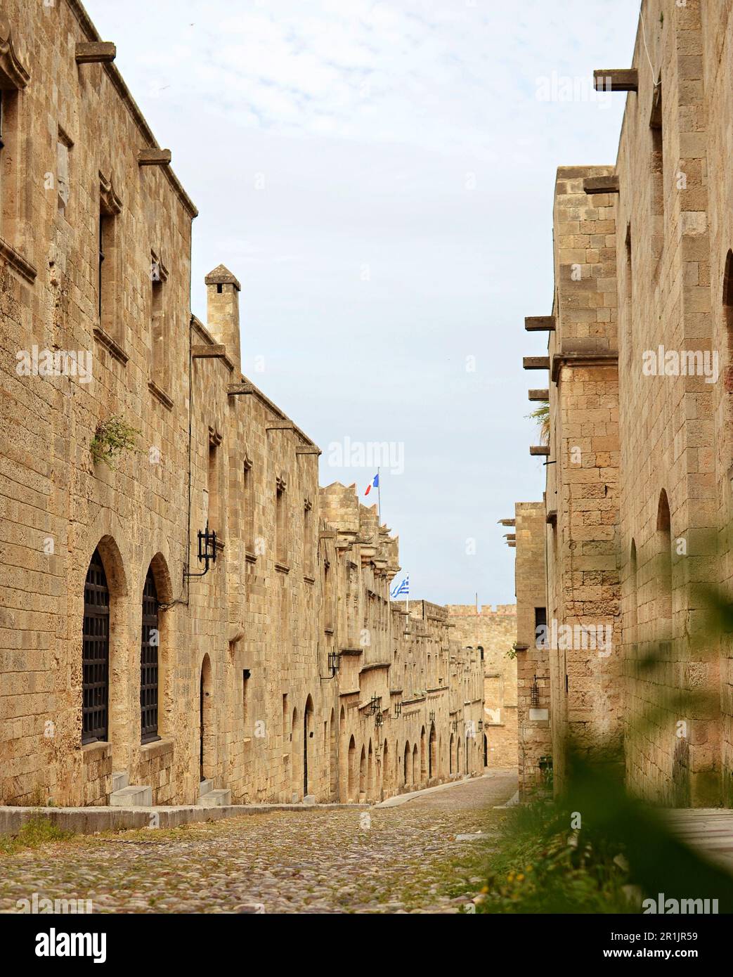 Medieval street of knights with paving stones and stone houses on the ...