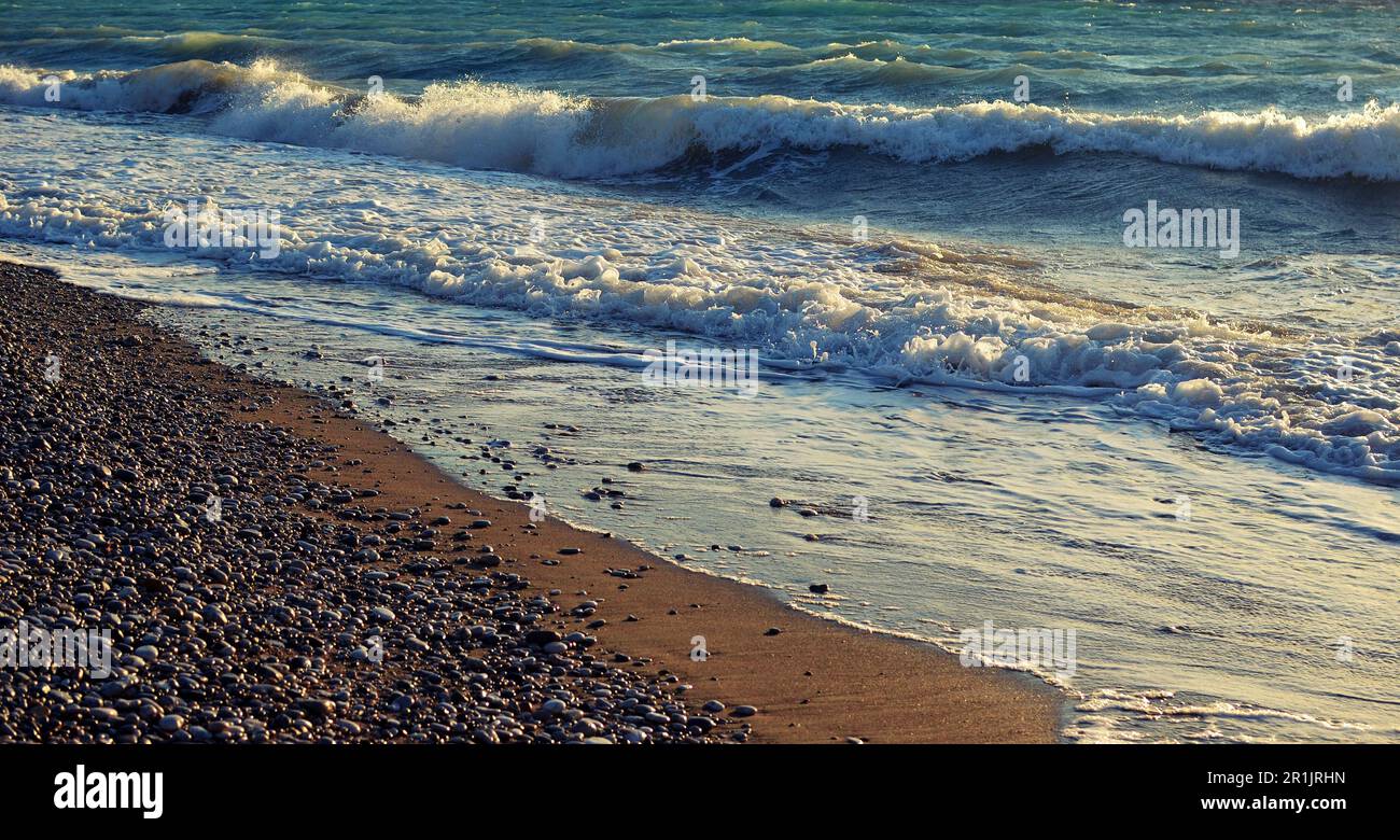 Sea coast of the Mediterranean. Shoreline with pebble beach and white ...