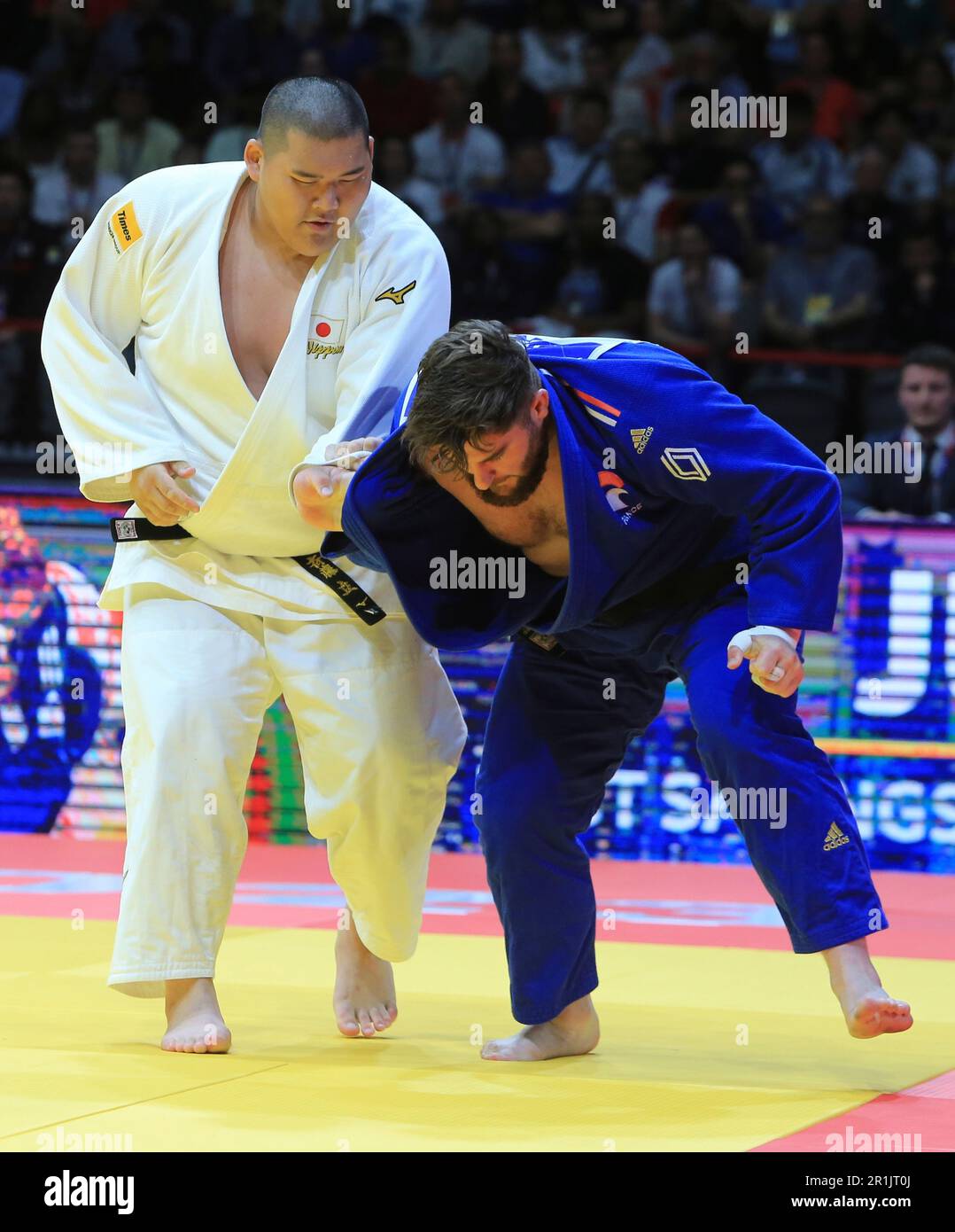 Tatsuru Saito of Japan, in white, and Joseph Terhec of France compete ...