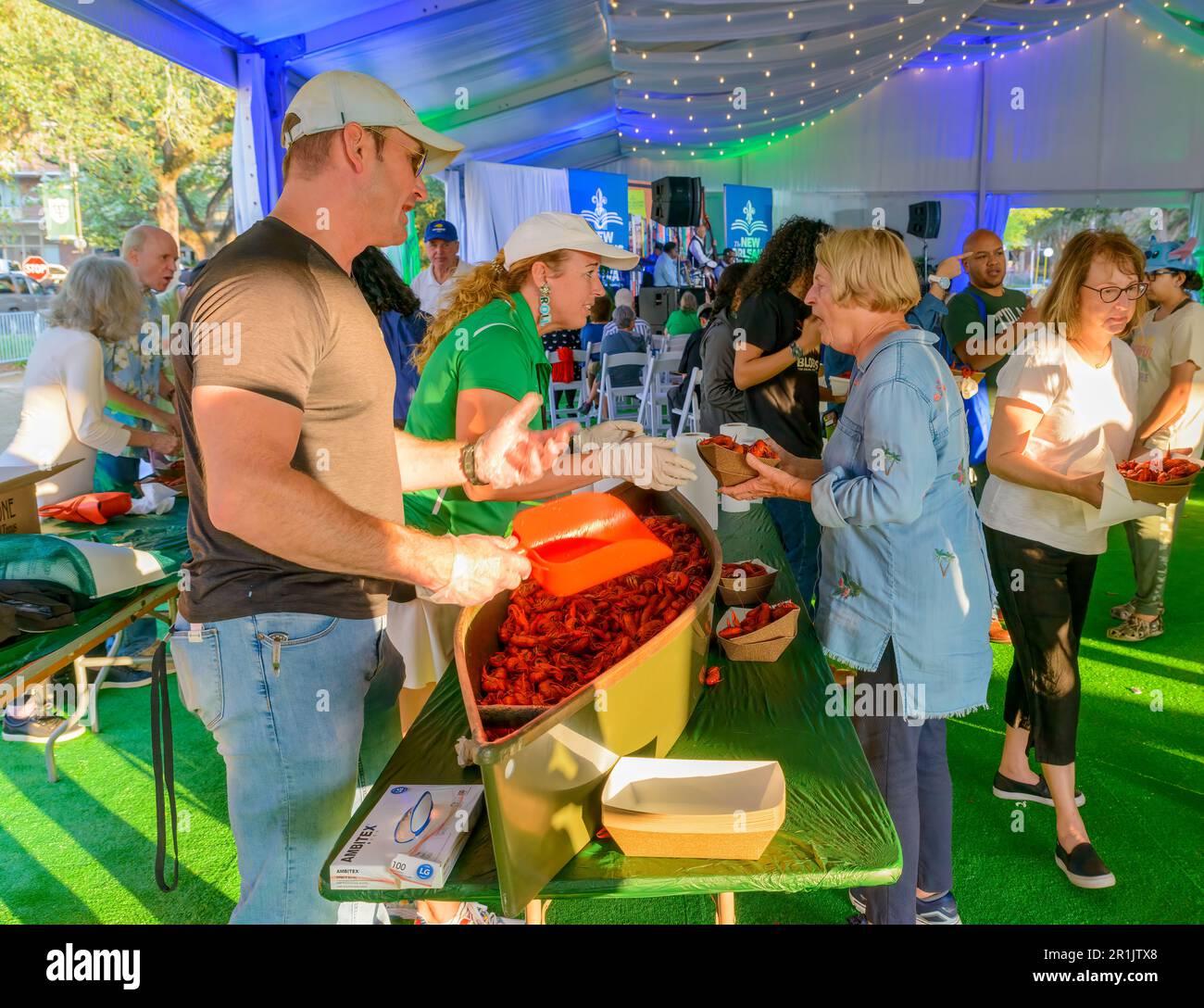 NEW ORLEANS, LA, USA - MARCH 11, 2023: People being served crawfish at ... NEW ORLEANS, LA, USA - MARCH 11, 2023: People being served crawfish at ...