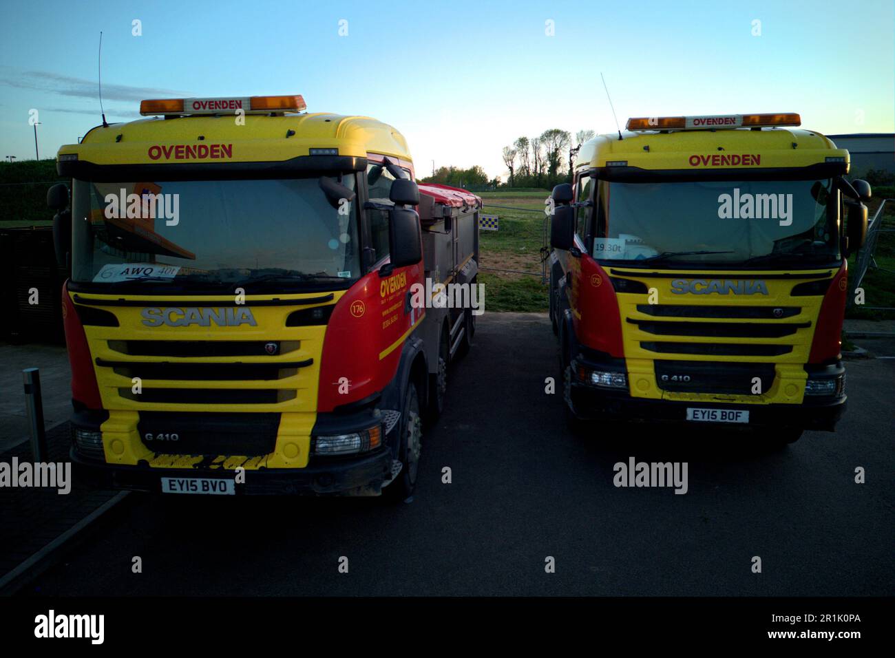 Two road lorries waiting to deliver construction supplies, parked up ...