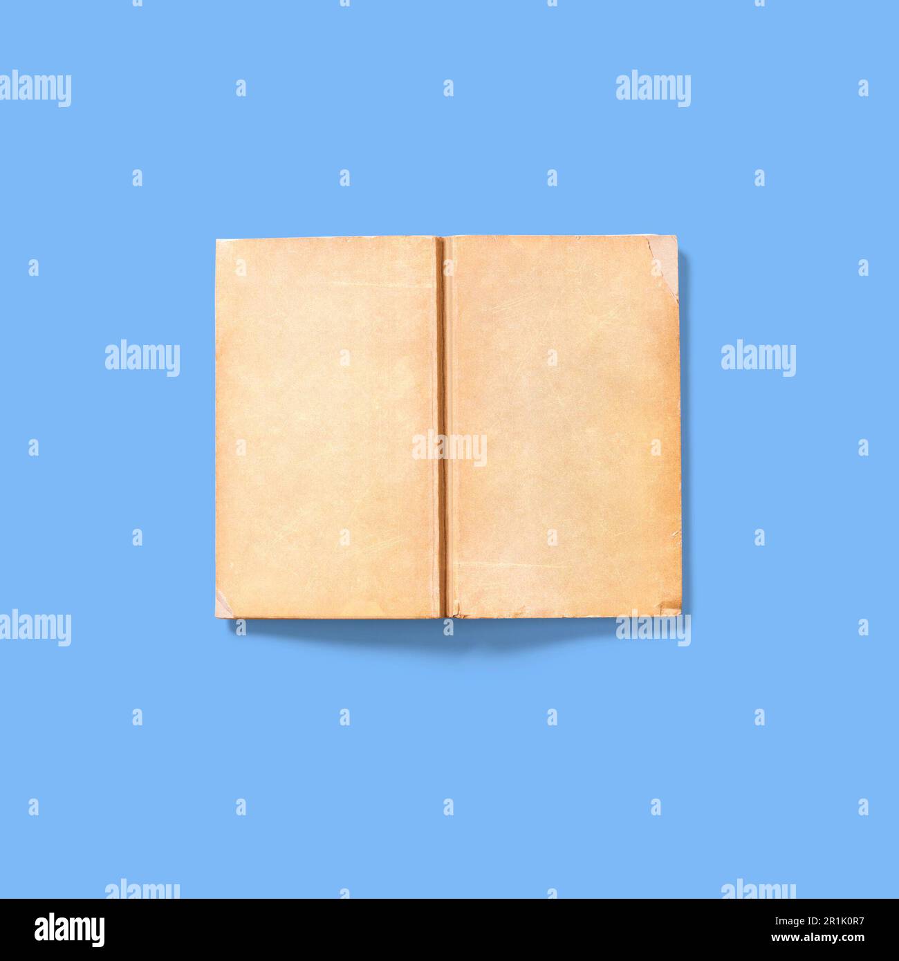 Soft book cover upside down open , isolated on blue background. vintage ...