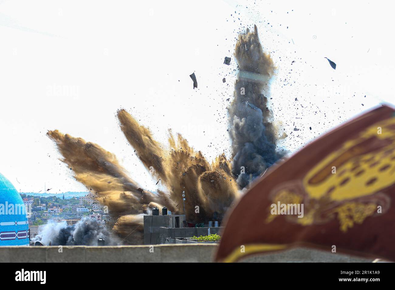 Smoke and debris fly into the sky as a building was hit by an Israeli ...