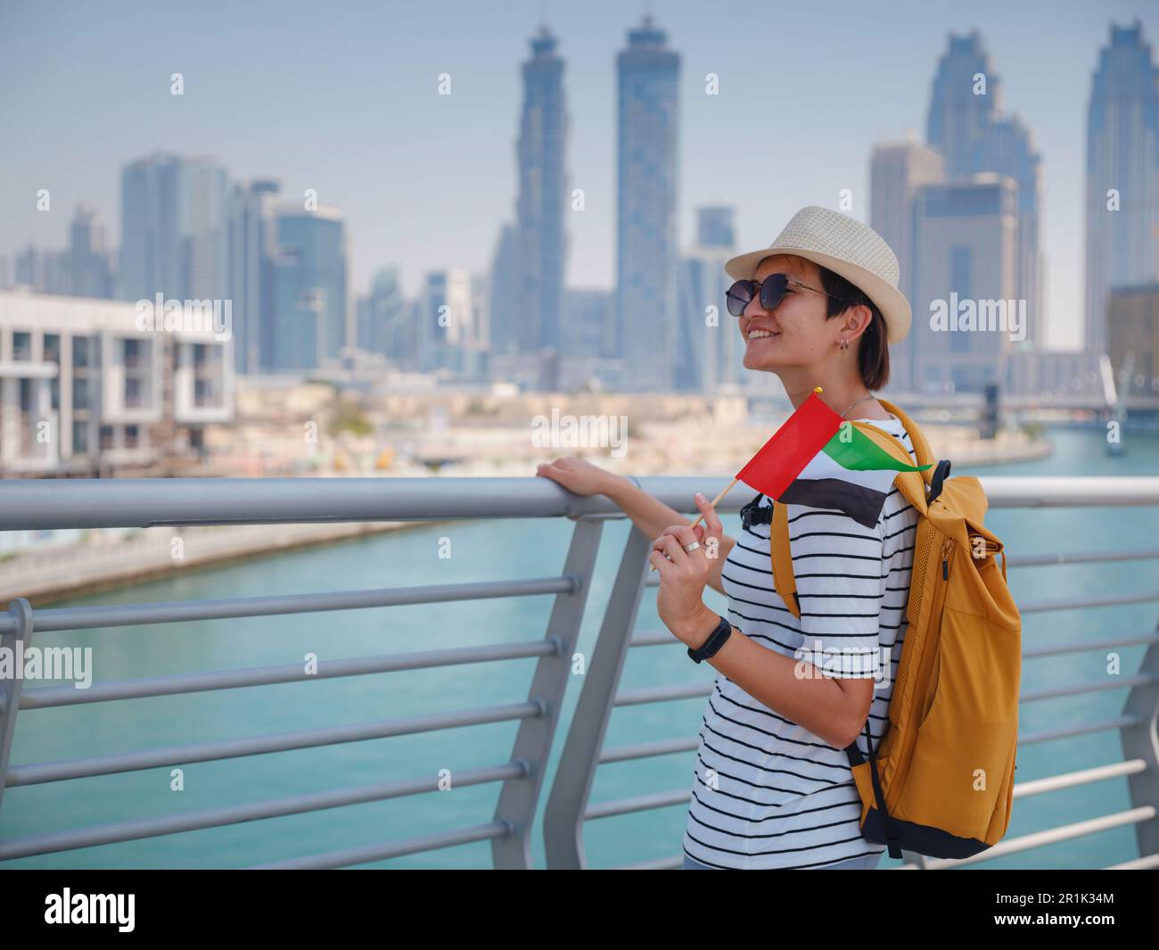asian happy traveler woman with hat and yellow backpack with the flag ...