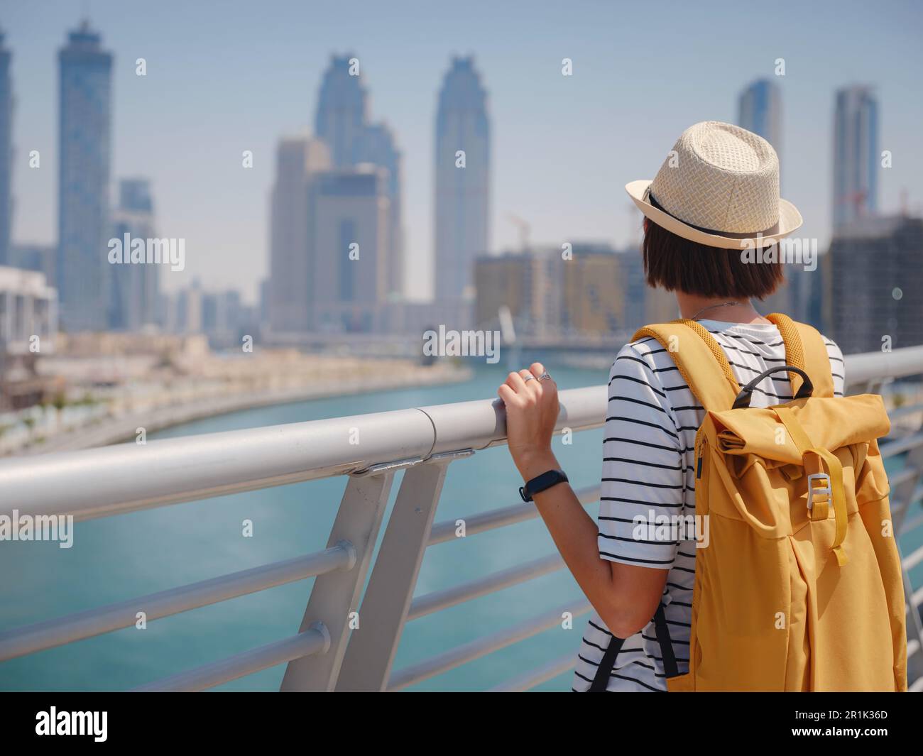 asian happy traveler woman with hat and yellow backpack enjoys stunning ...