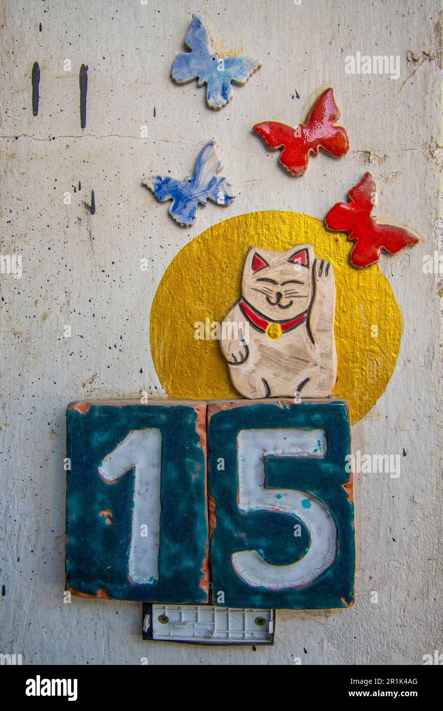 A sign with the number 15, butterflies, and a cat. Concepcion of design ...