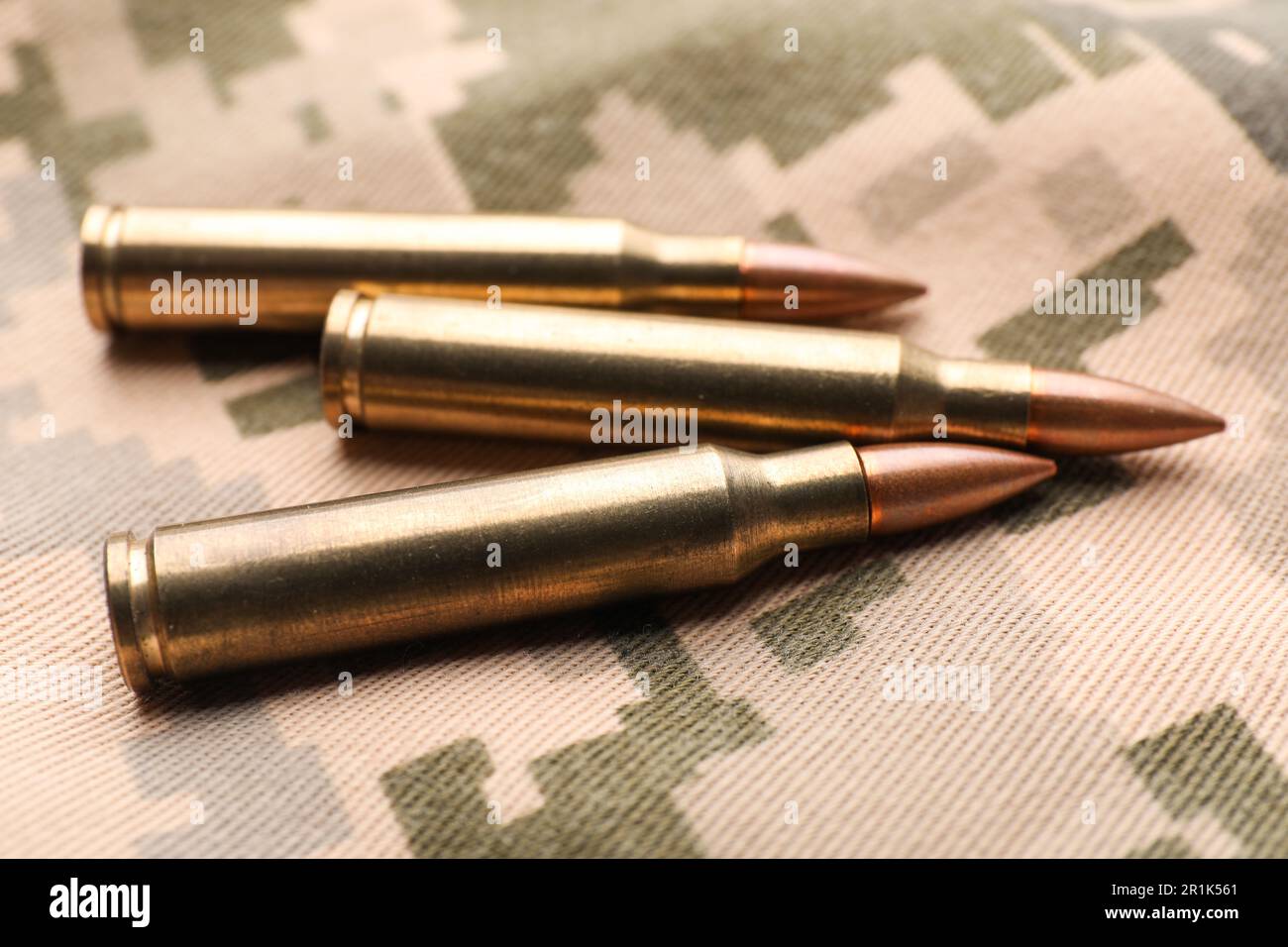 Military bullets on pixel Ukrainian camouflage, closeup Stock Photo - Alamy