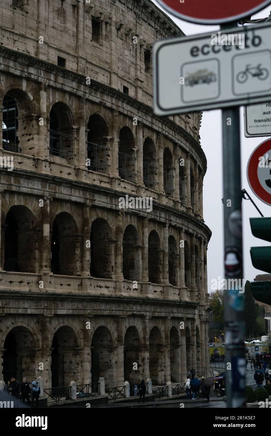 The iconic Colosseum in Rome, Italy on a rainy day, with traffic signs ...
