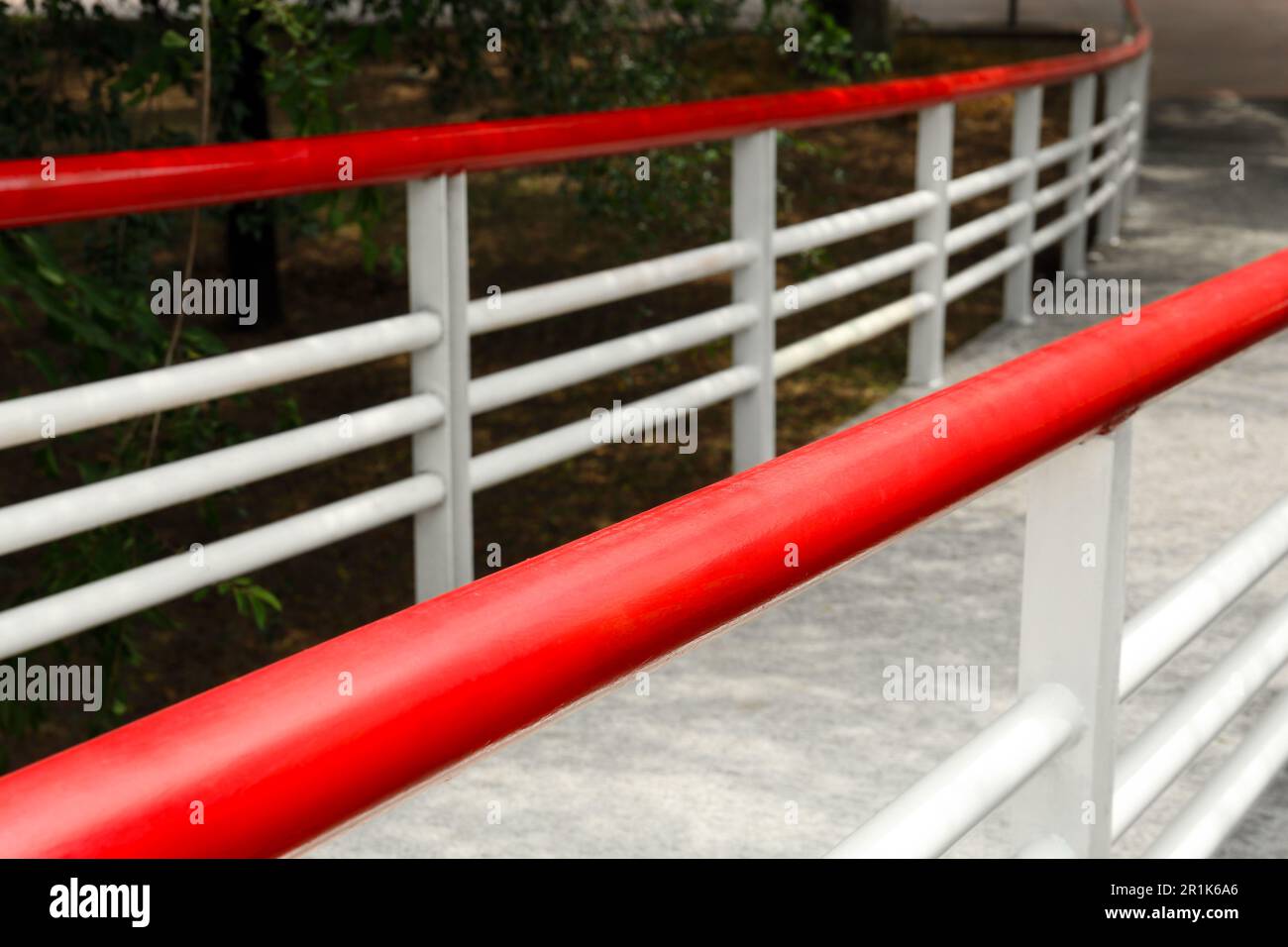 Ramp with red metal handrailings near trees outdoors Stock Photo - Alamy