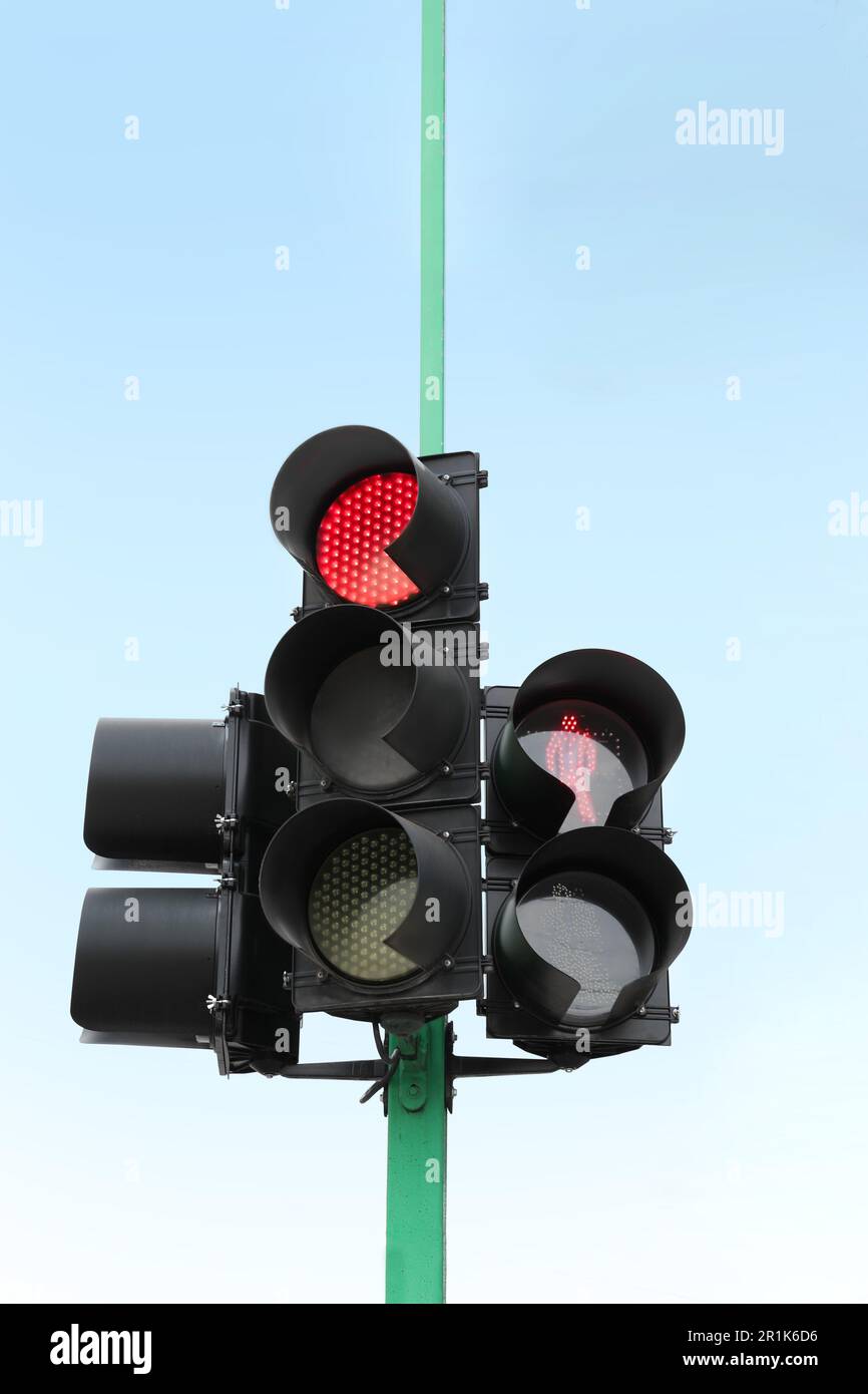 Traffic lights with red signals against blue sky Stock Photo - Alamy
