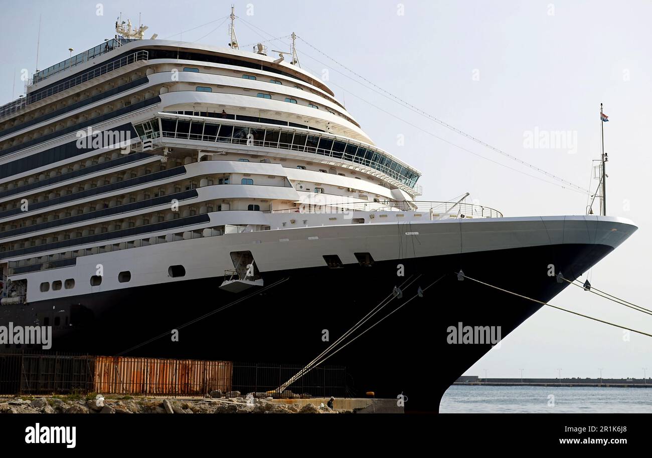 The nose of a huge cruise ship parked in the port of the island of ...