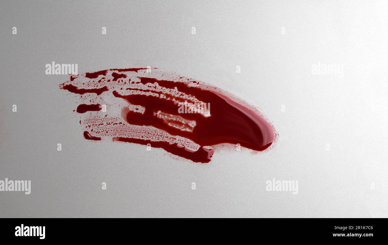 Stain of blood on grey background, top view Stock Photo - Alamy