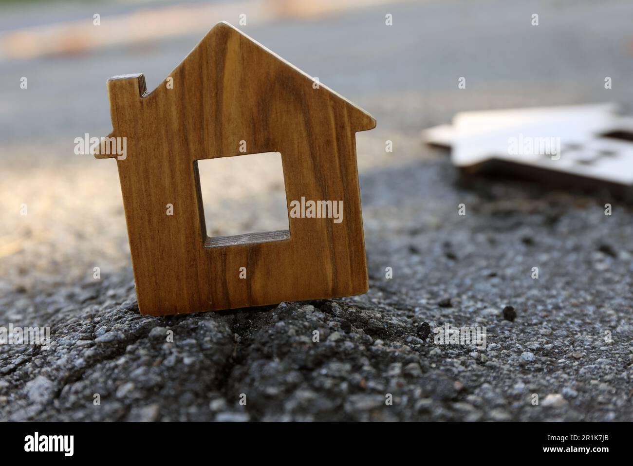 Wooden house model on cracked asphalt. Earthquake disaster Stock Photo ...