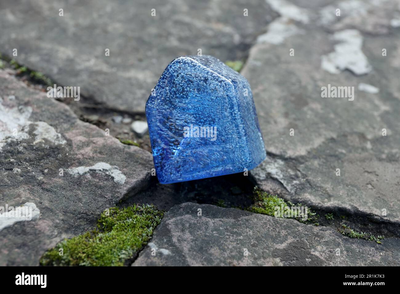 Glass house model between cracks on stone road. Earthquake disaster ...