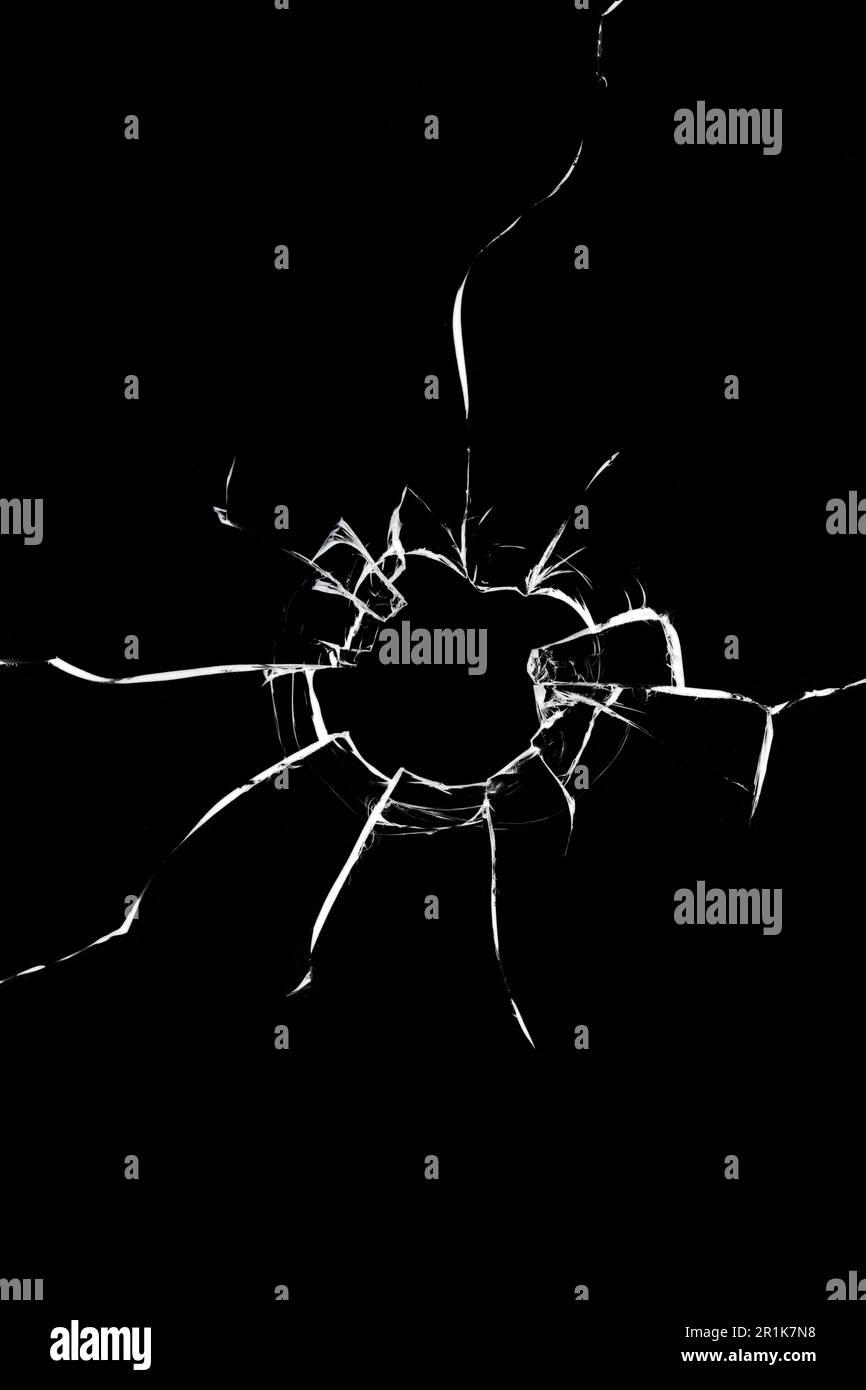 Cracked broken glass on a black background. Damaged window texture ...