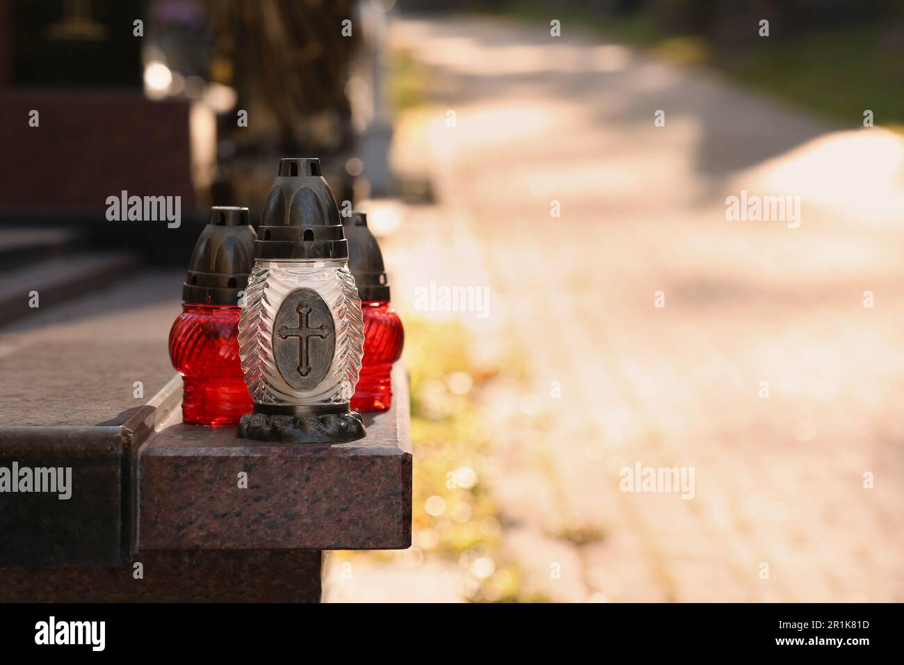 Grave lanterns on granite surface in cemetery, space for text Stock Photo - Alamy