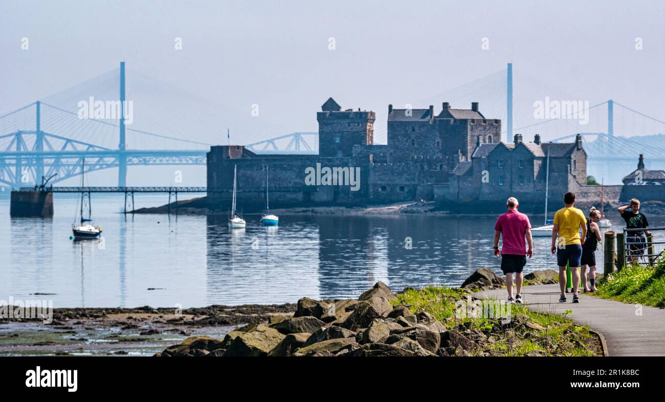 People walking on coastal path near Blackness Castle with bridges in ...