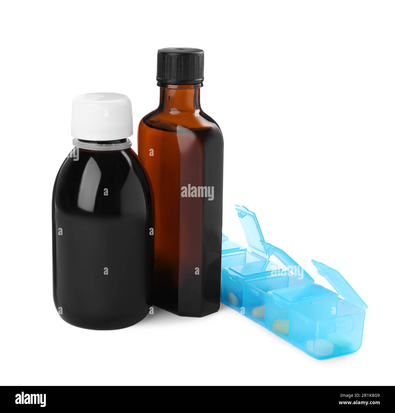 Bottles of syrups with pills on white background. Cough and cold ...