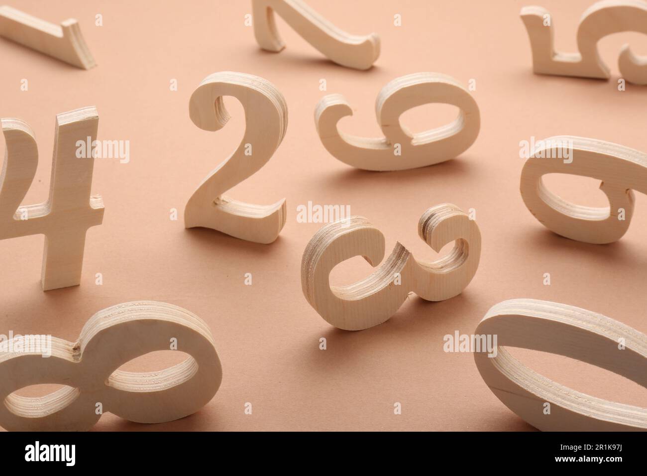 Many different wooden numbers on beige background Stock Photo - Alamy