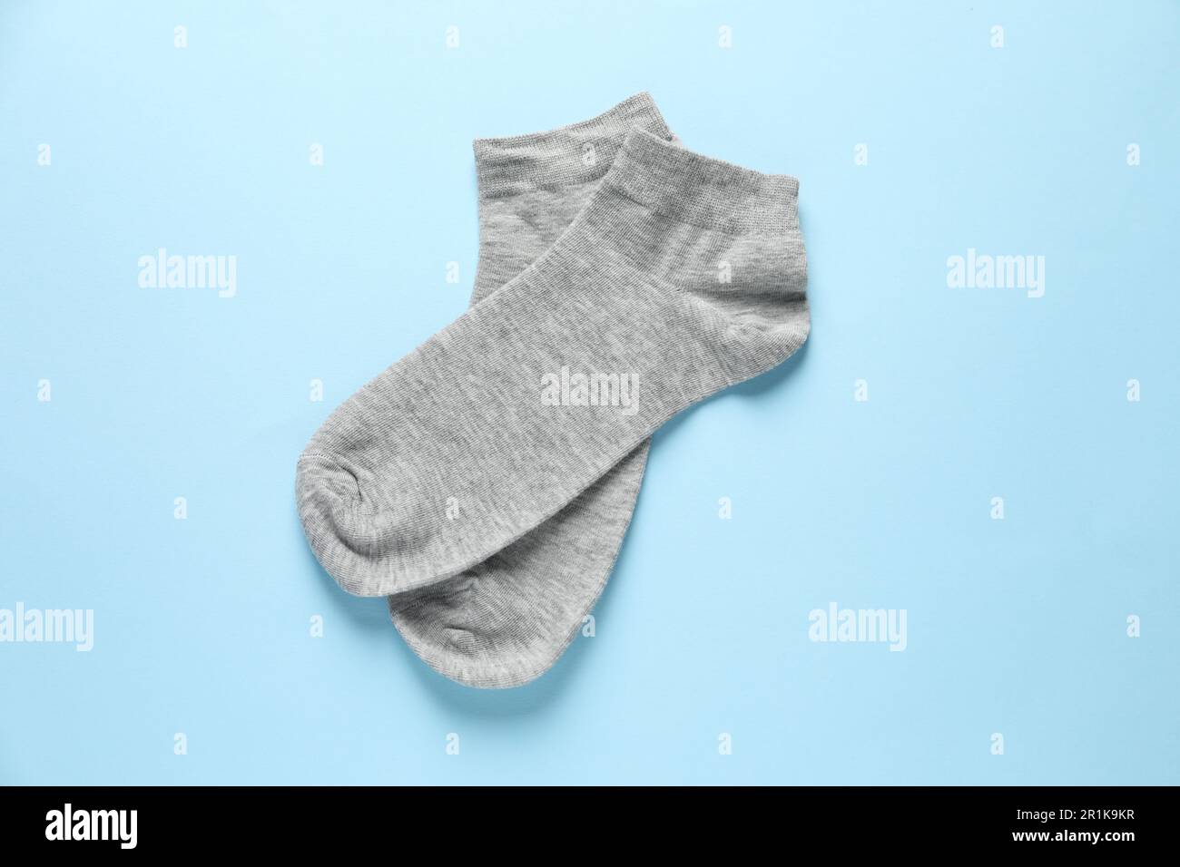 Pair of grey socks on light blue background, flat lay Stock Photo - Alamy