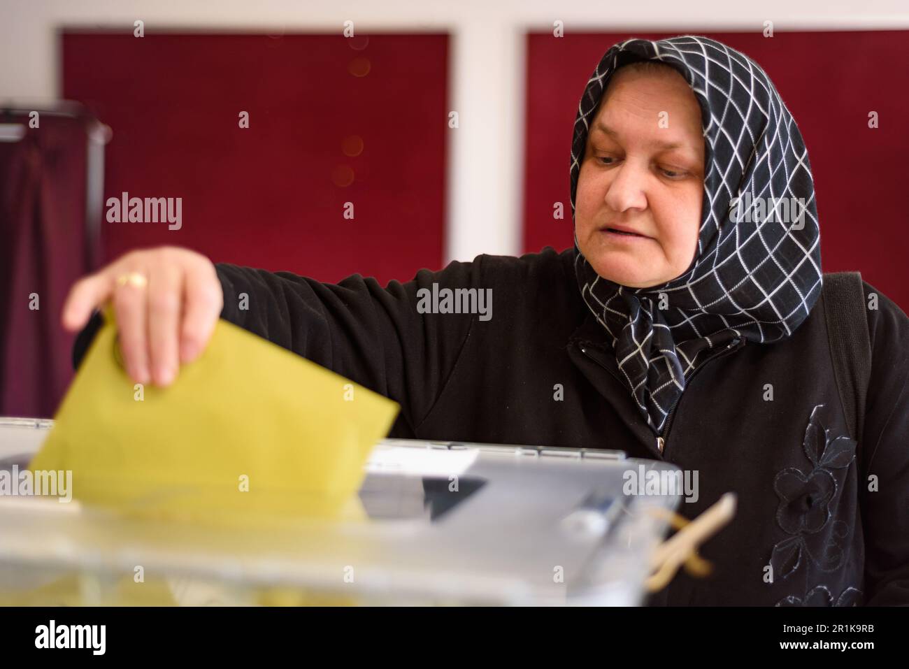 Istanbul, Turkey. 14th May, 2023. A woman casts her vote in a ballot ...