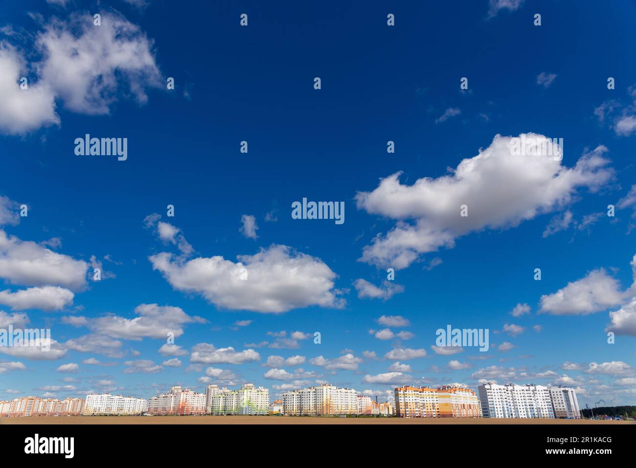 Deep blue skies with white clouds background and modern multi-storey ...