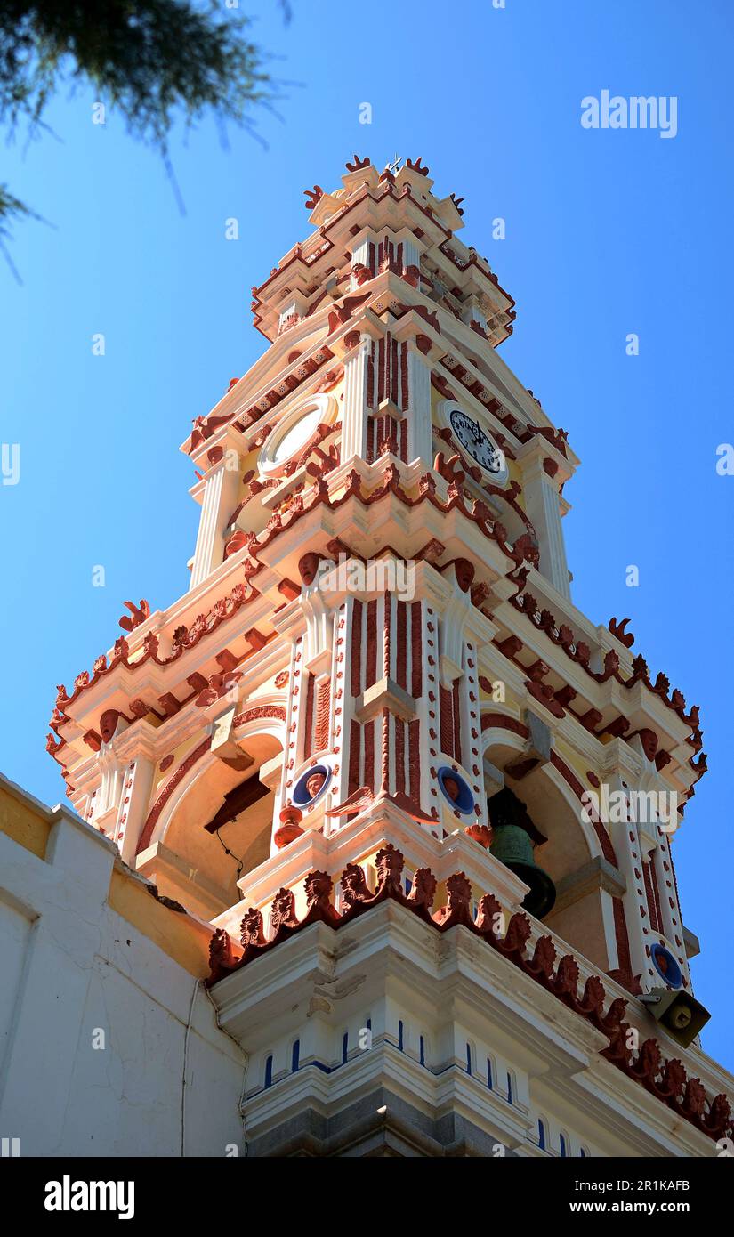 Close-up of a church bell tower with decorations, yellow-brown. Bell ...