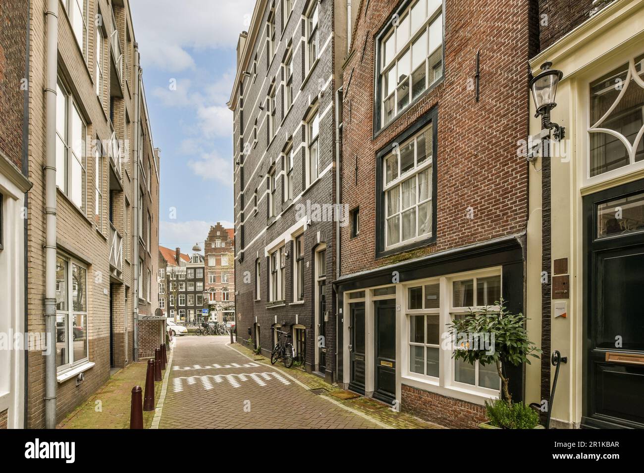 an empty street in the middle of a city with buildings on both sides ...