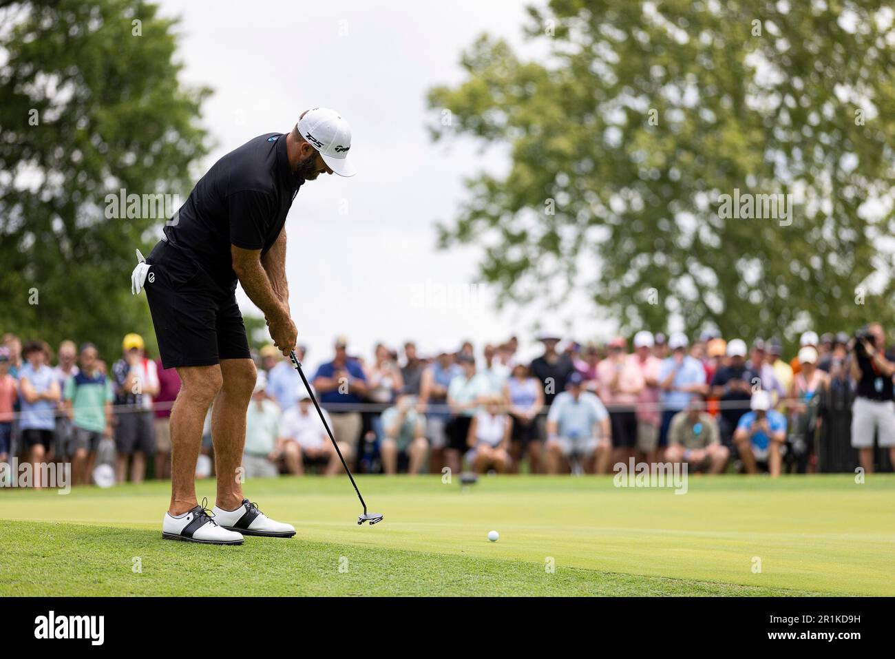 Captain Dustin Johnson of 4Aces GC putts on the fourth green during the ...