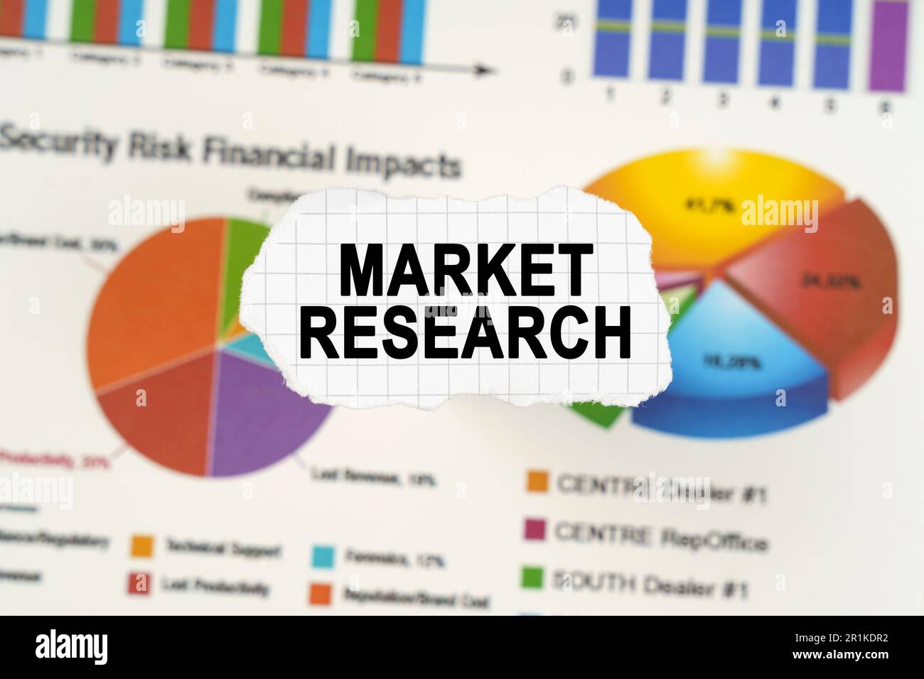 Business concept. On diagrams and graphs lies torn paper with the ...