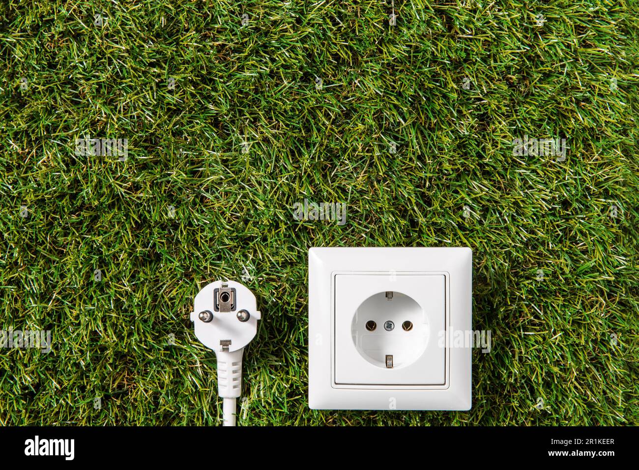 Green socket with power plug and cable on green grass hi-res stock ...