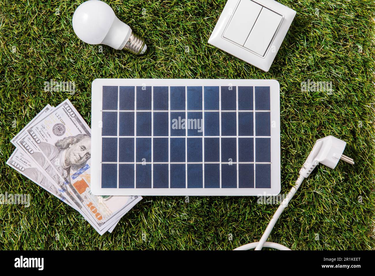 solar battery, bulb, money, bills and calculator Stock Photo - Alamy