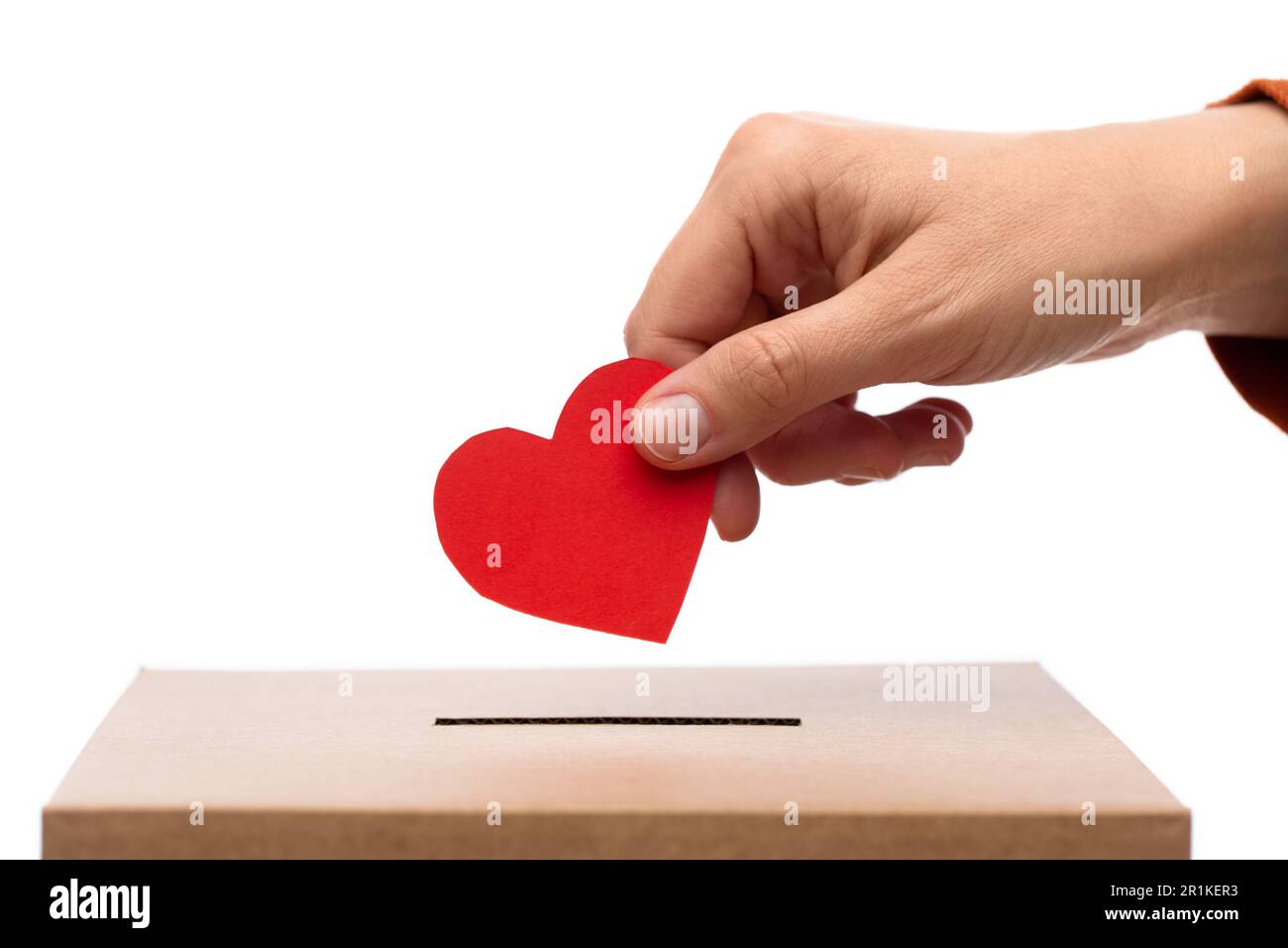 hand putting red heart into charity donation box Stock Photo - Alamy