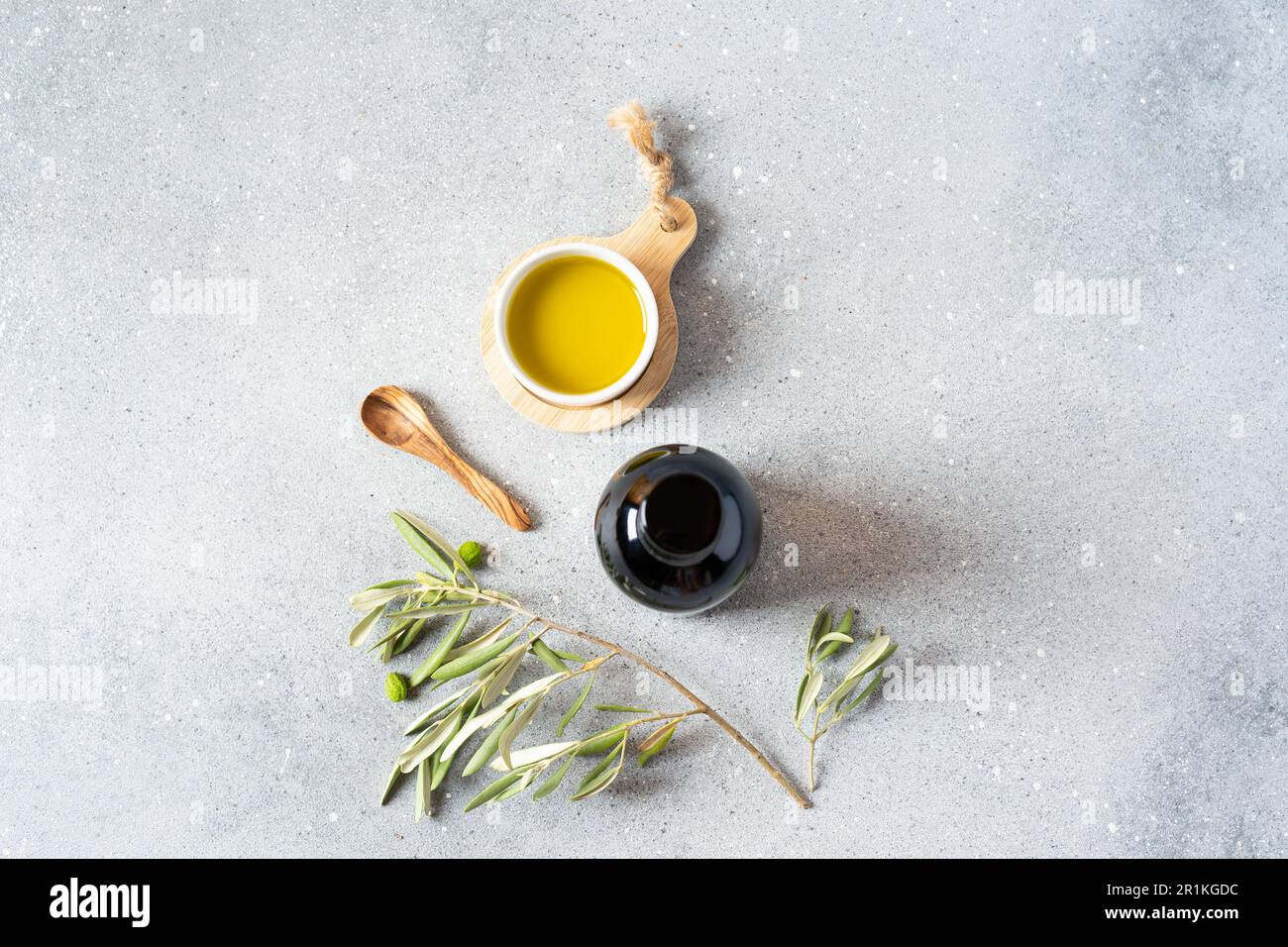 Homemade organic olive oil in a black glass bottle. A sprig of the ...