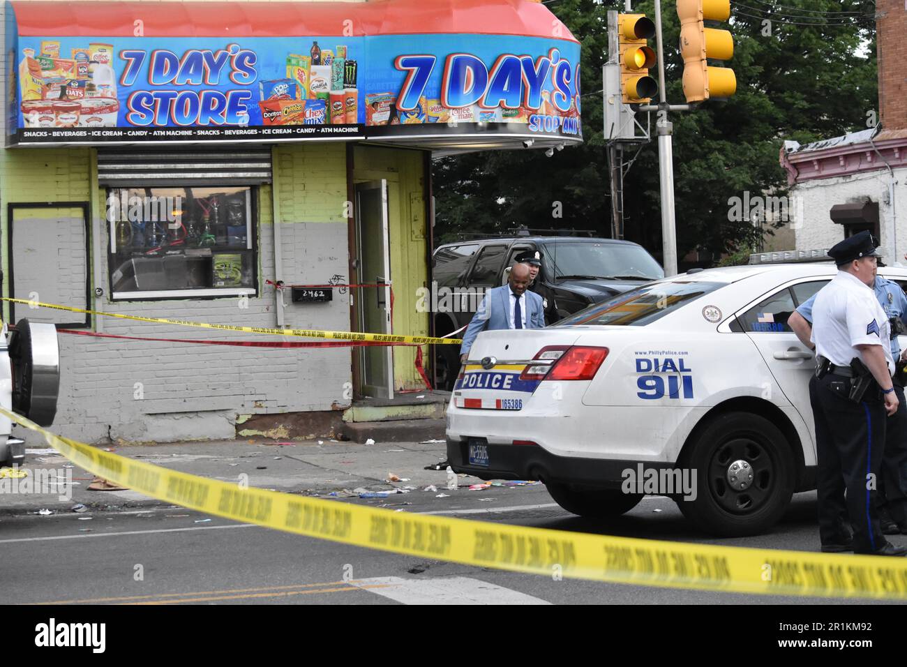 Crime scene tape cordons off the area and Philadelphia police vehicles ...