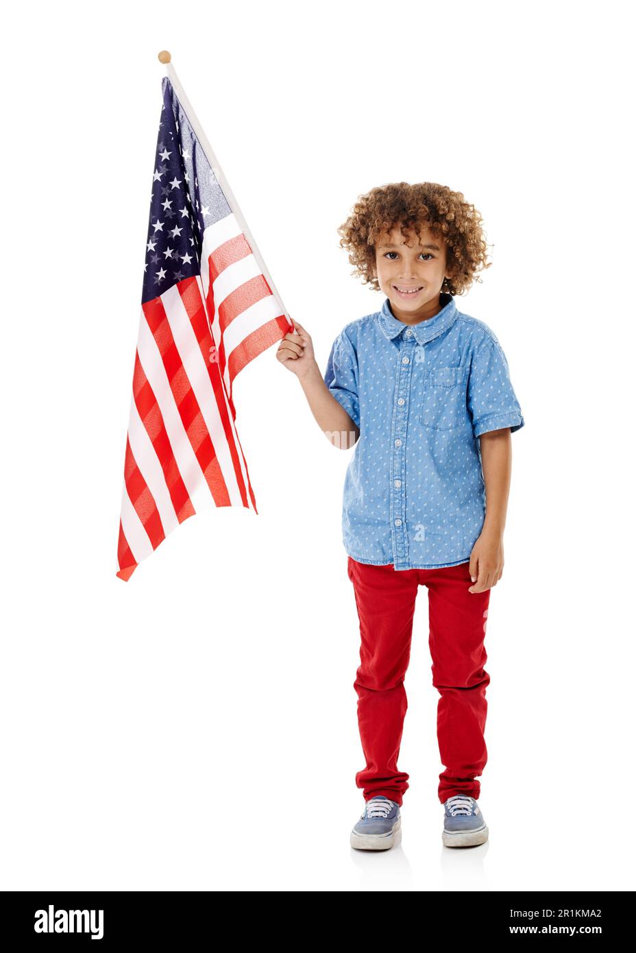 Fly it with pride. Studio shot of a cute little boy holding the ...