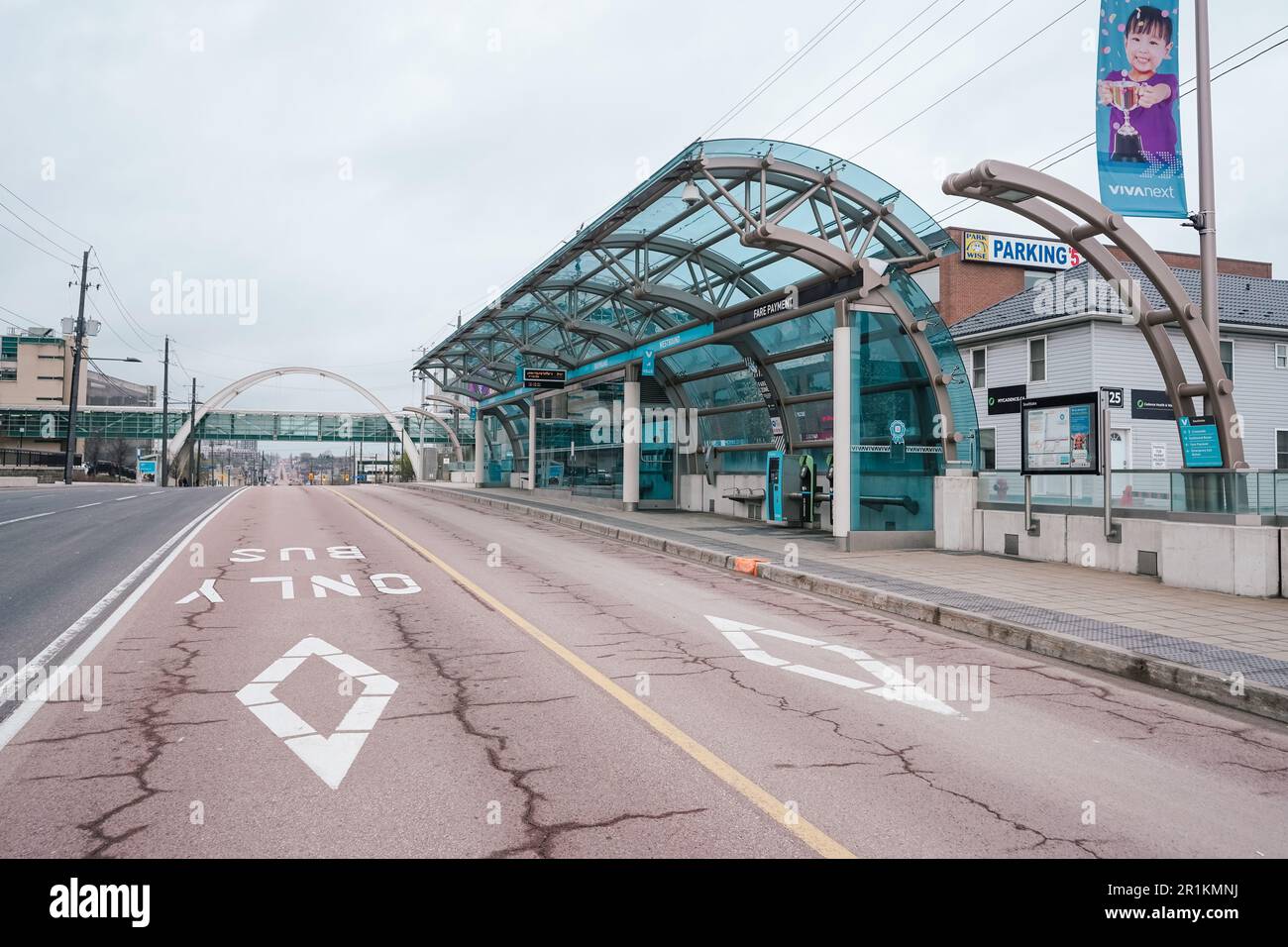 An outdoor bus shelter, features curved tubular steel trusswork ...