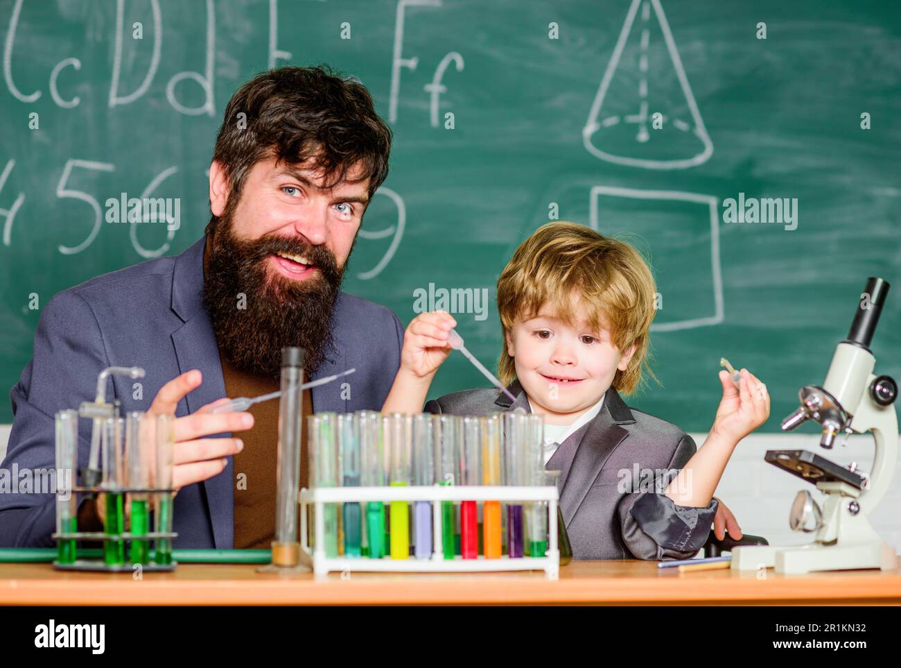 Empowered by Innovation. Little kid learning chemistry in school ...