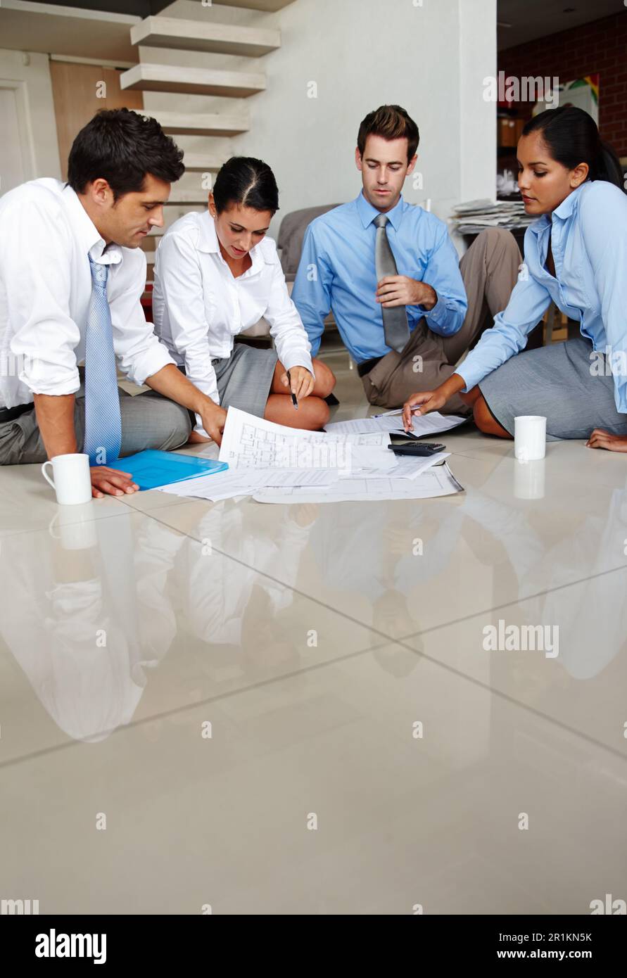 Getting a new perspective. Four business colleagues going over the ...