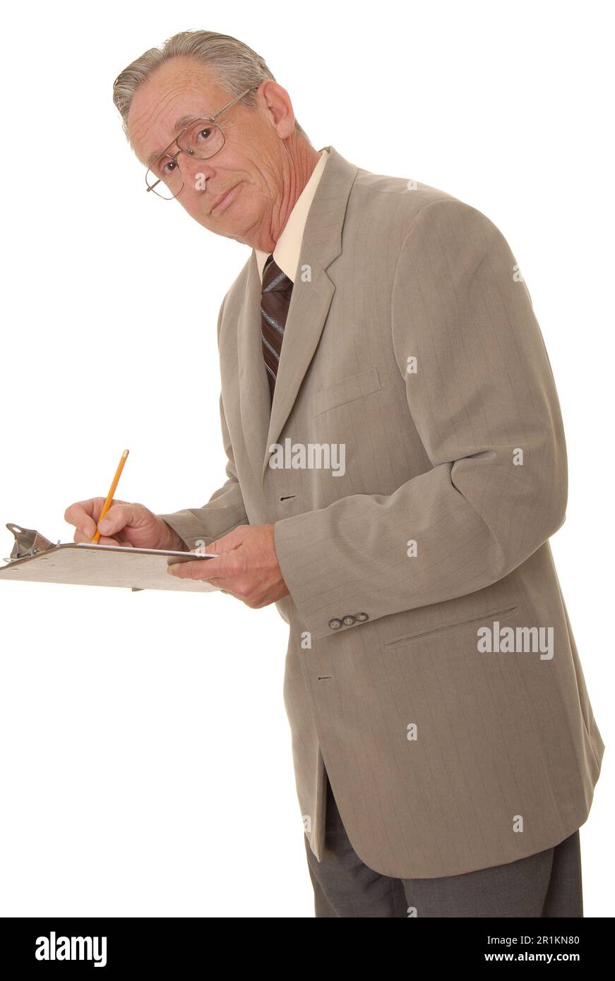 Senior businessman taking notes on a clipboard Stock Photo - Alamy
