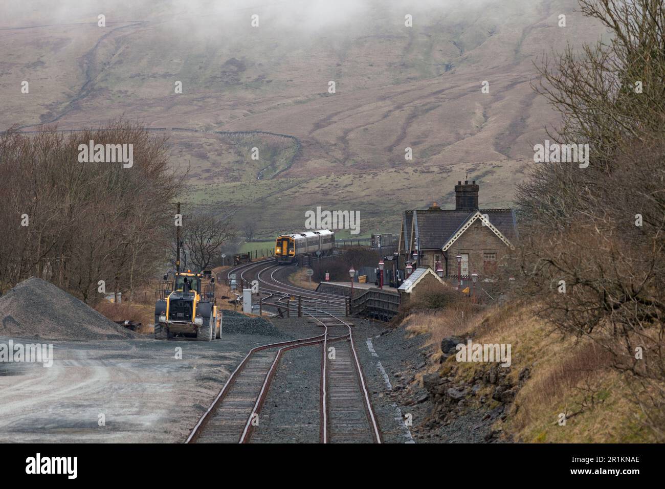 Viewed from the quarry freight sidings a Northern Rail class 158 DMU ...