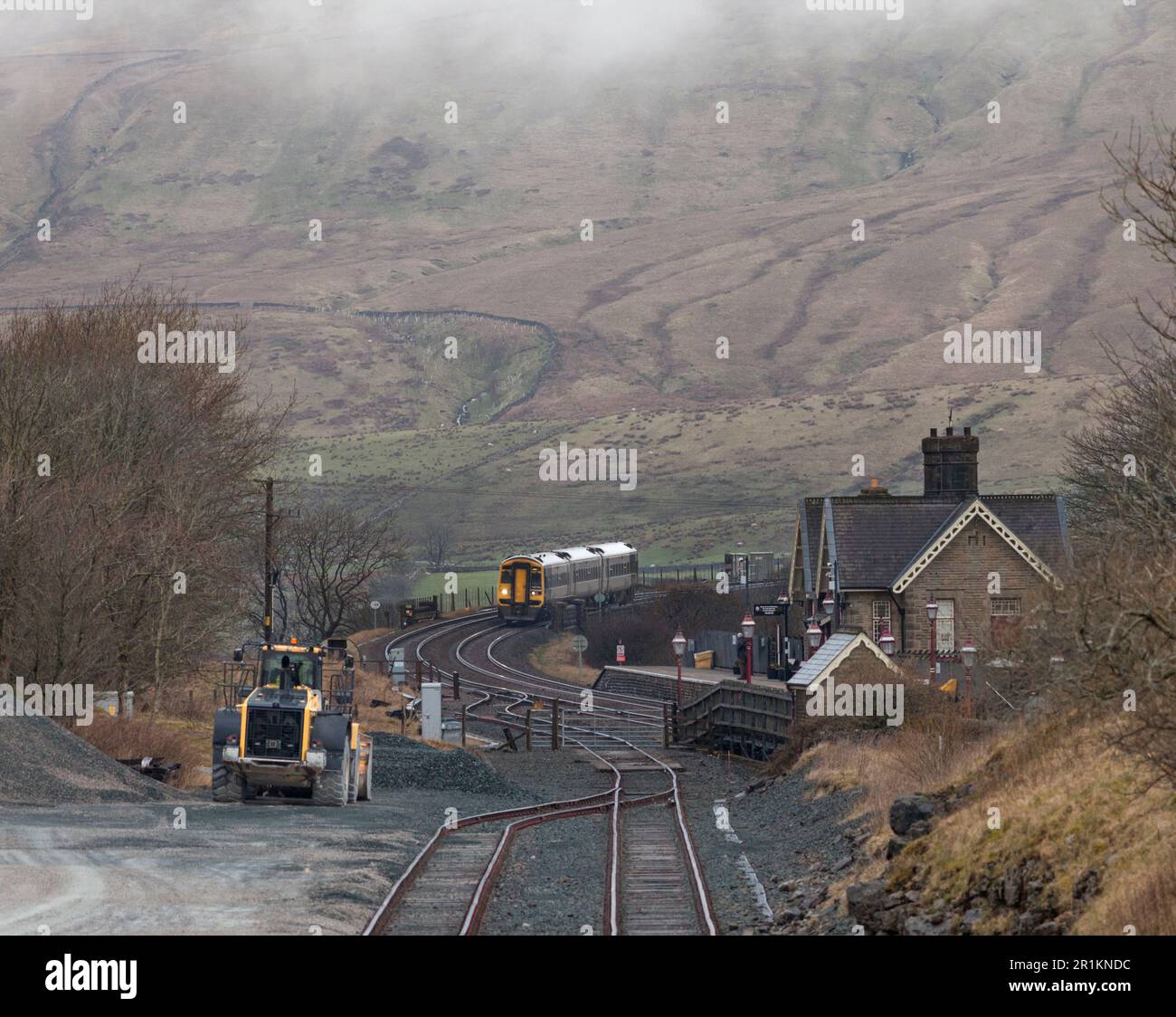 Viewed from the quarry freight sidings a Northern Rail class 158 DMU ...